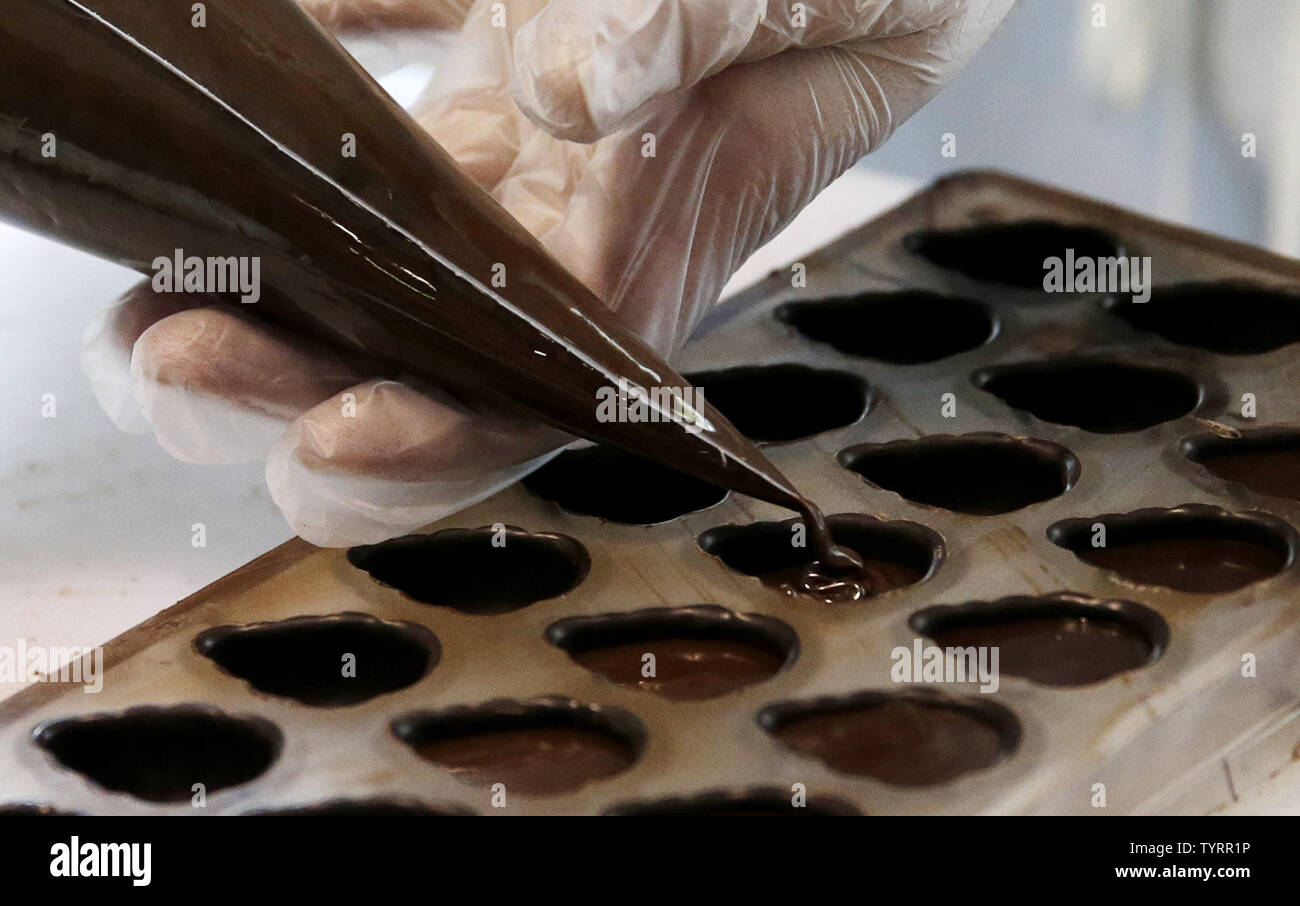 Chocolatiere Michael Donaghy makes chocolate candy in an exhibit of ...