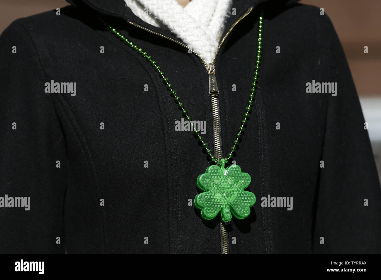 A reveler wears a shamrock neckless on the parade route at the St ...