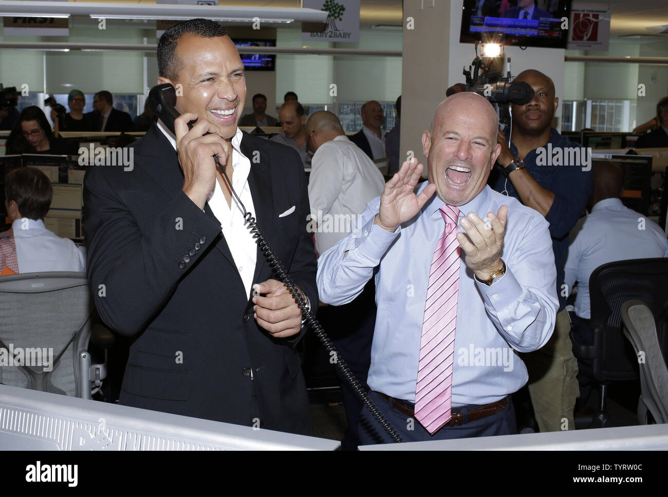 BTIG Co-Founder Steven Starker smiles as Alex Rodriguez speaks to a ...