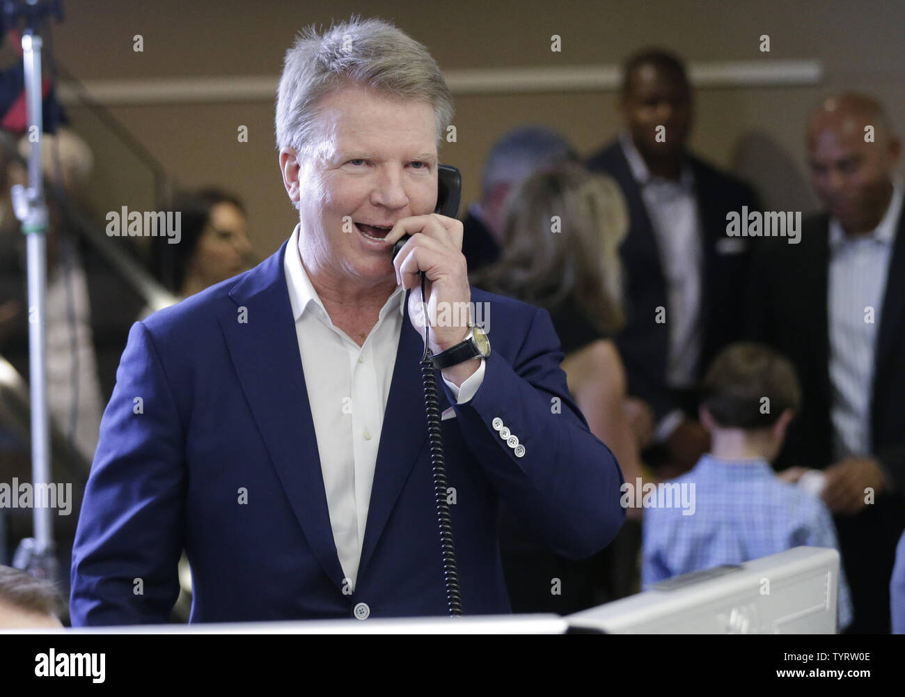 Phil Simms speaks to a client at the 2017 BTIG Commissions for Charity ...