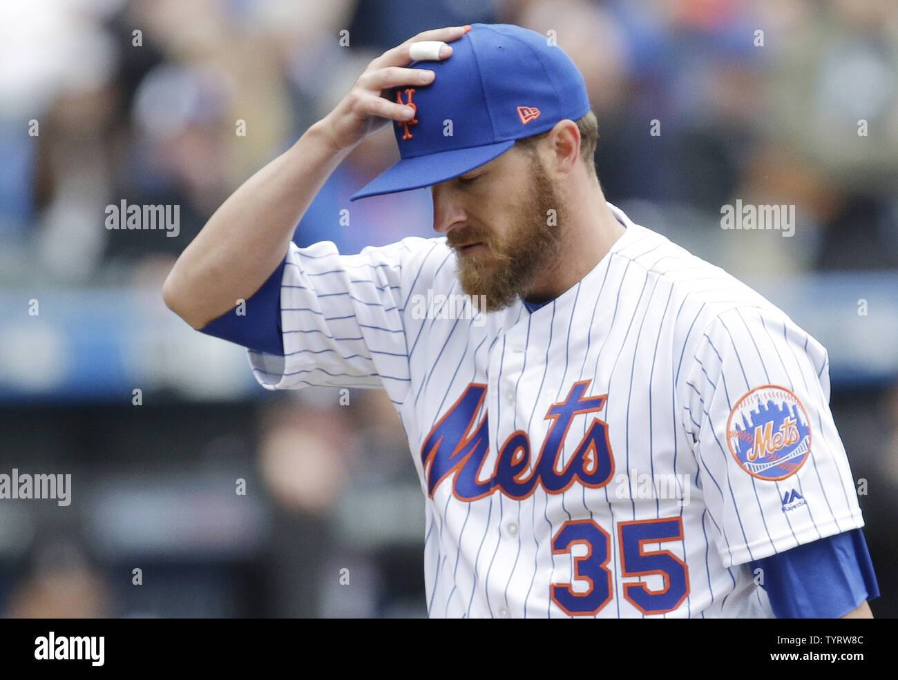 New York Mets starting pitcher Adam Wilk grabs his hat as he walks to ...