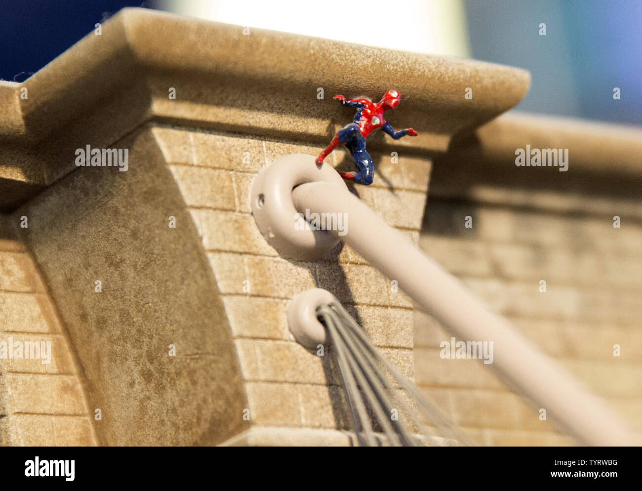 A miniature Spiderman at the top of a model of the Brooklyn Bridge in ...