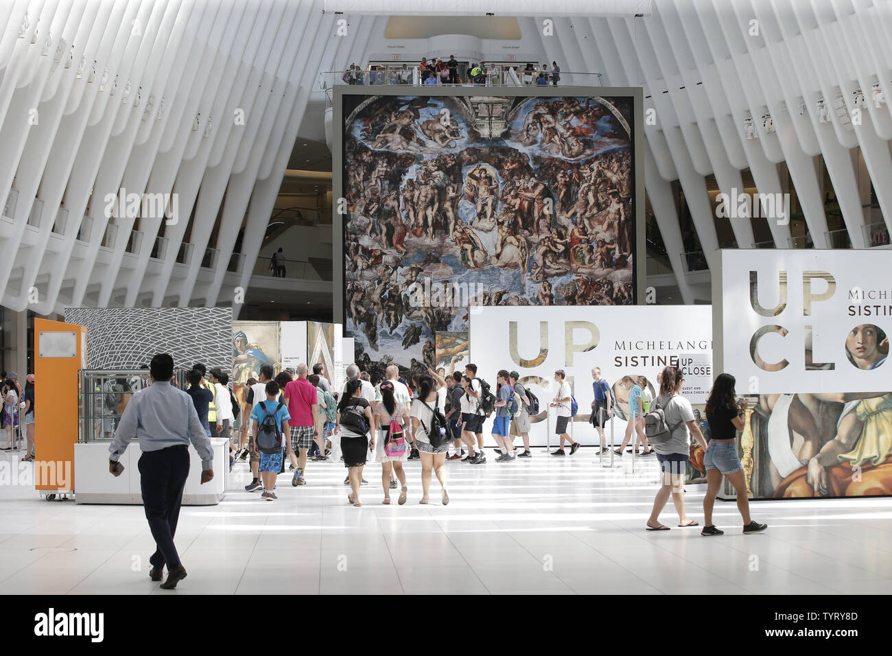 People walk by painting reproductions of Michelangelo at a press ...