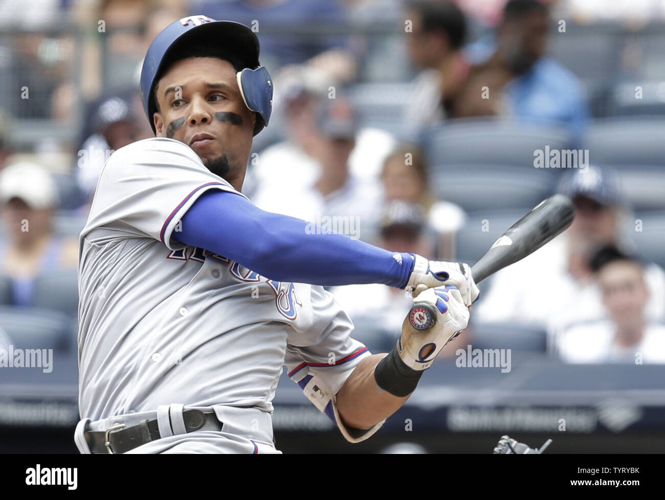 Texas Rangers Carlos Gomez has his helmet come loose when he takes a ...