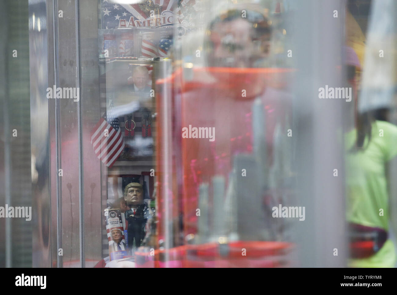 A man walks by a display of American Flags, President Donald Trump ...
