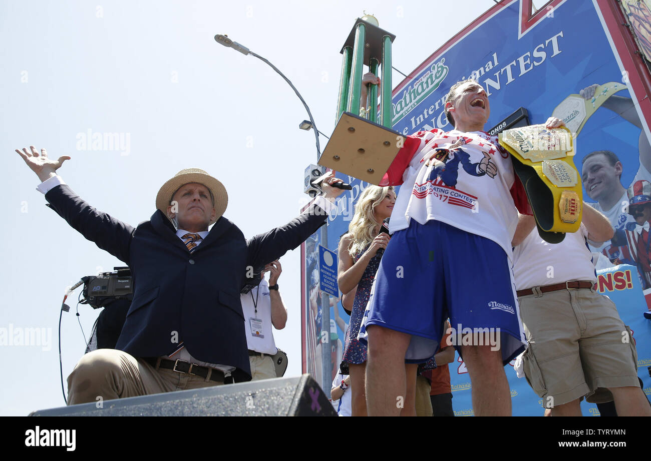 Joey Chestnut celebrates with a Trophy and Championship Belt after his ...