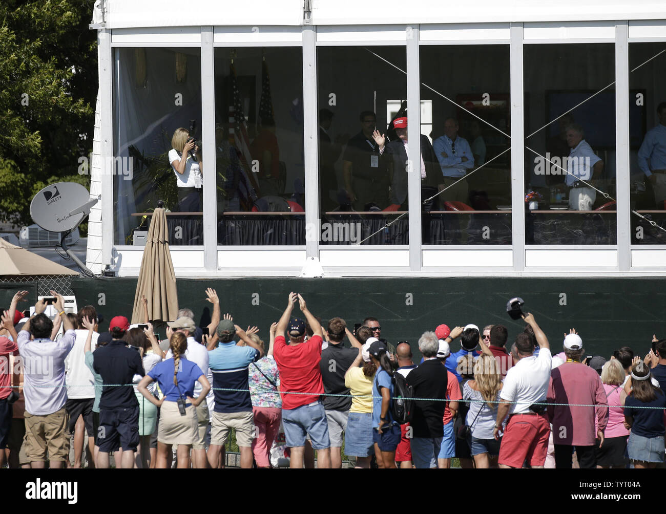 United States President Donald Trump waves at fans from his viewing ...