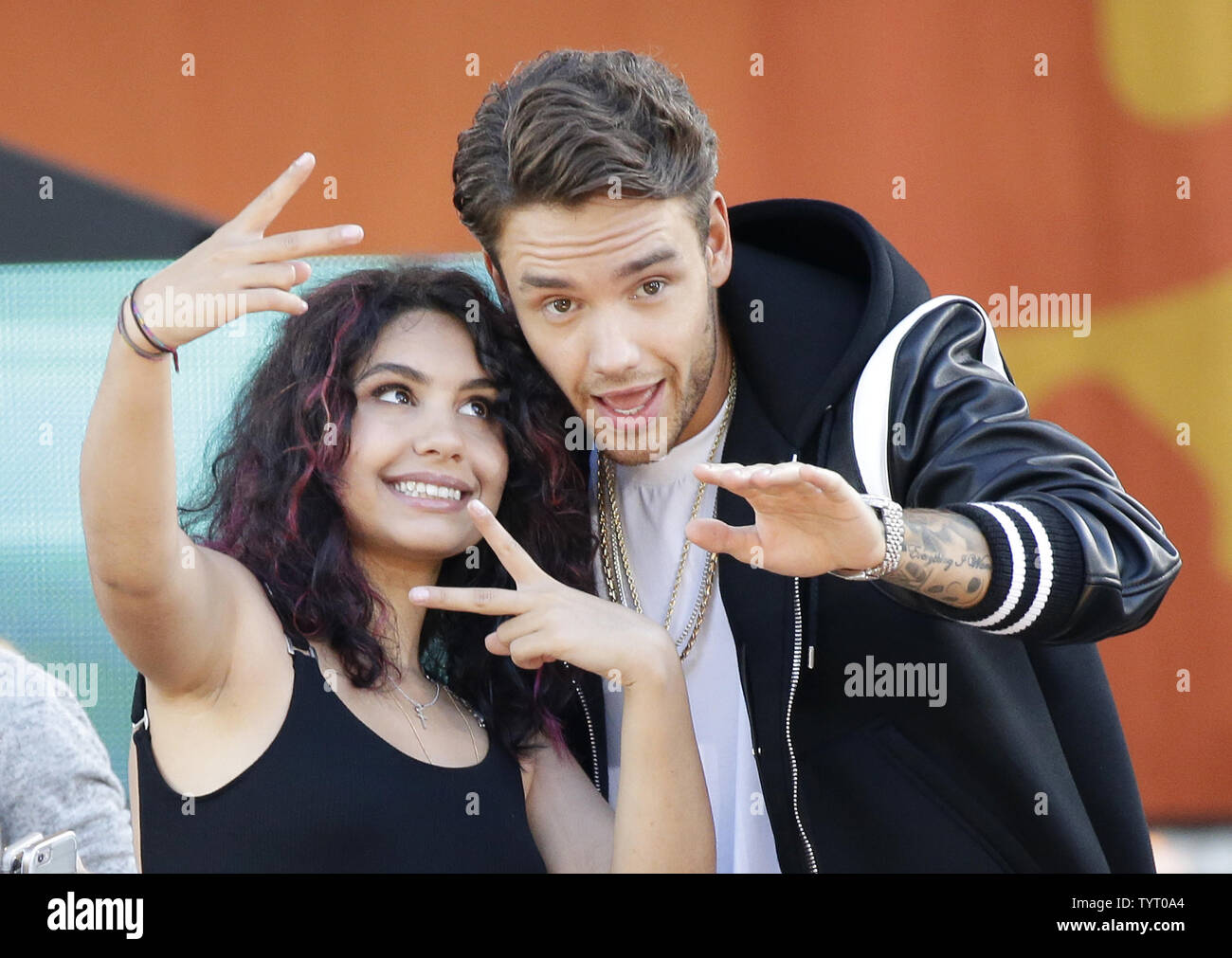 Alessia Cara and Liam Payne stand on the stage before they perform on ...