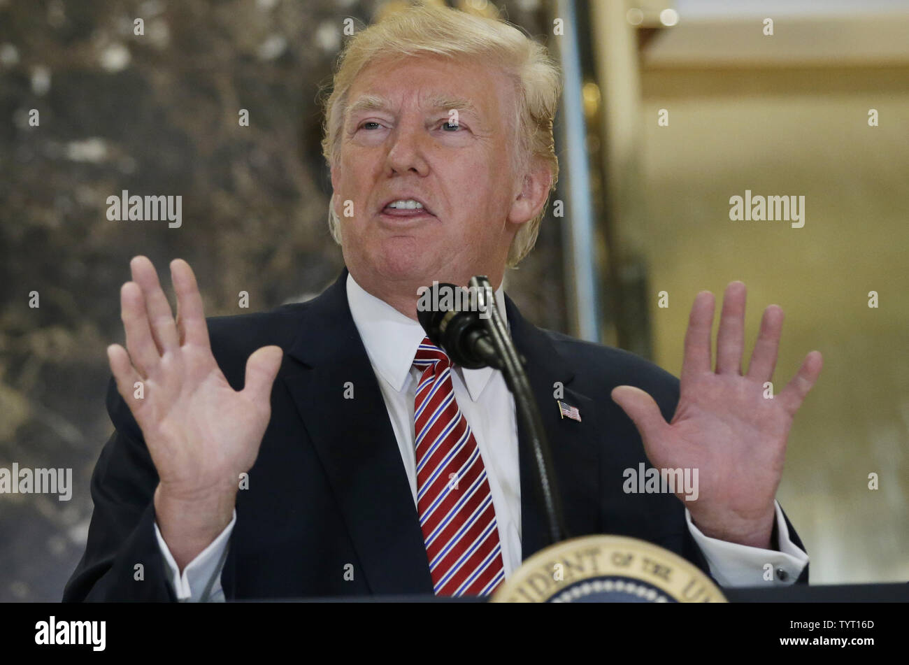 President Donald Trump raises his hands as he speaks after he ...