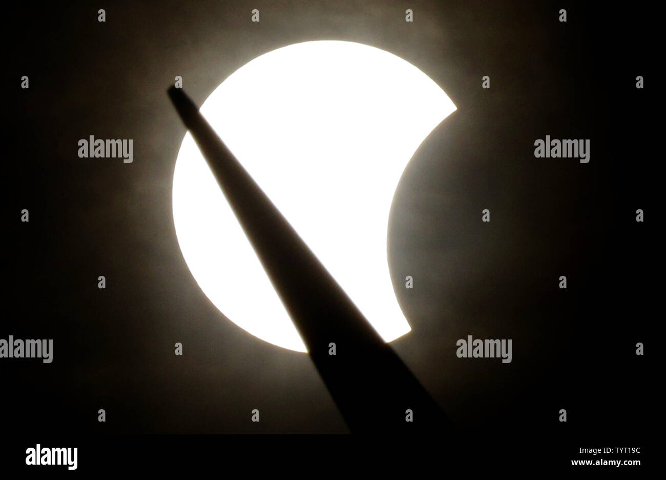 A partial solar eclipse moves across the sky near the Crown of the ...