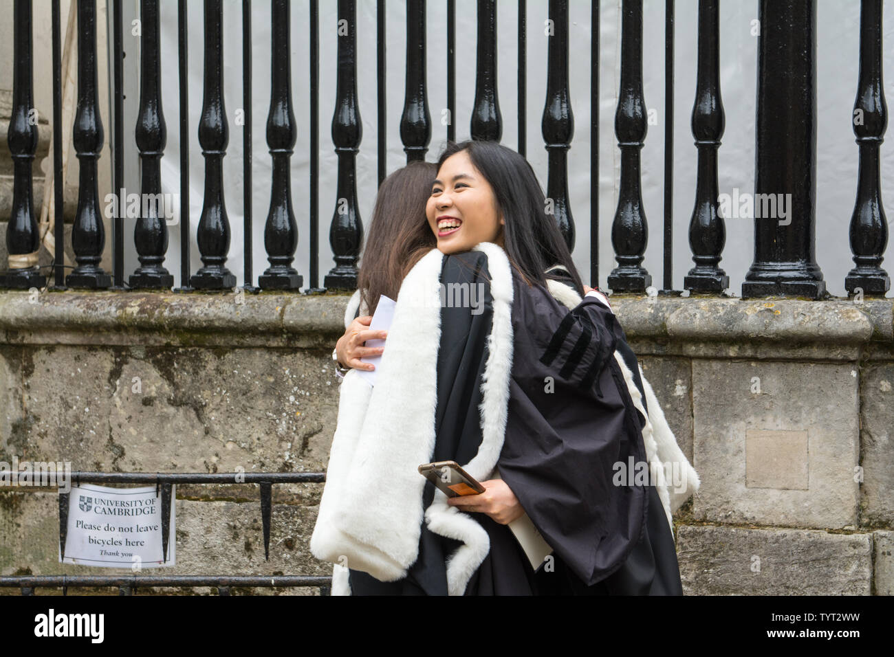 Cambridge uk, 2019-05-18, Two female graduates celebrate and ...