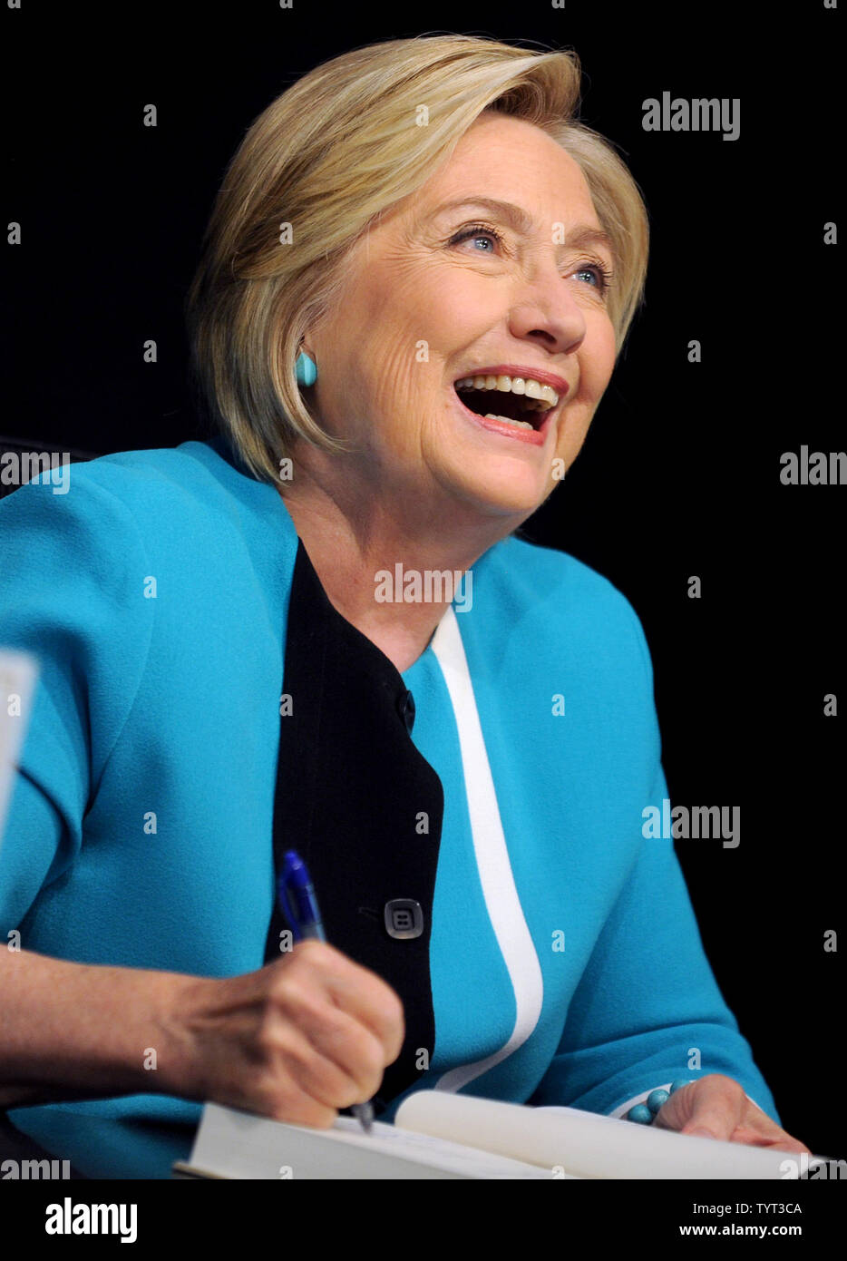 Former U.S. Secretary of State Hillary Clinton signs copies of her new ...