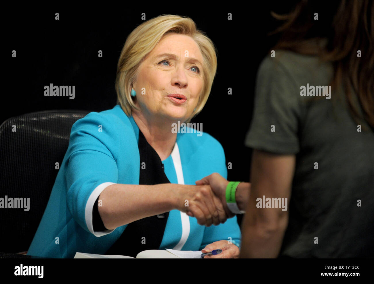 Former U.S. Secretary of State Hillary Clinton signs copies of her new ...