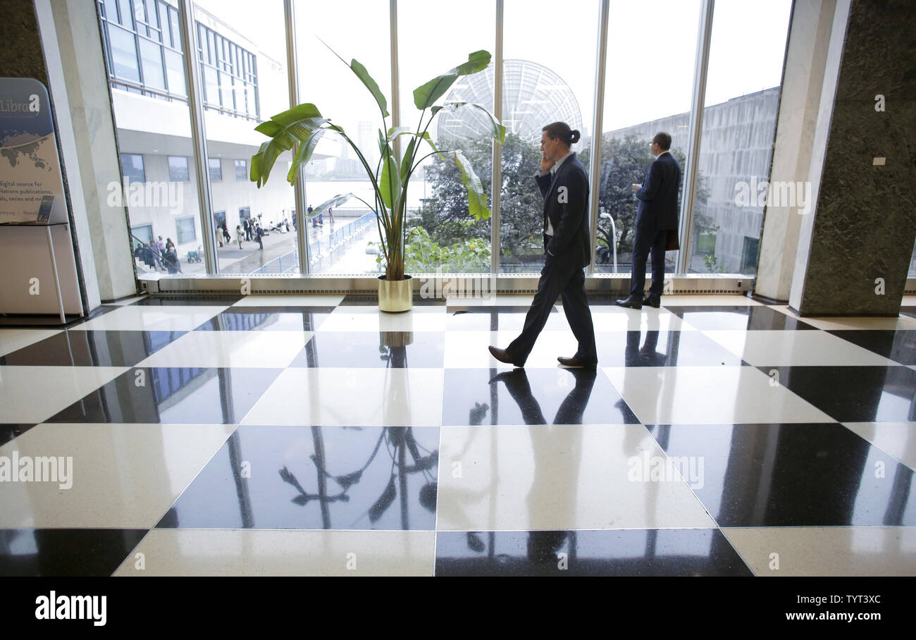 People walk through the lobby of the United Nations Building during the ...