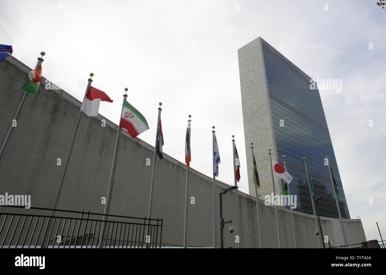 International flags fly at the base of the United Nations Building at ...