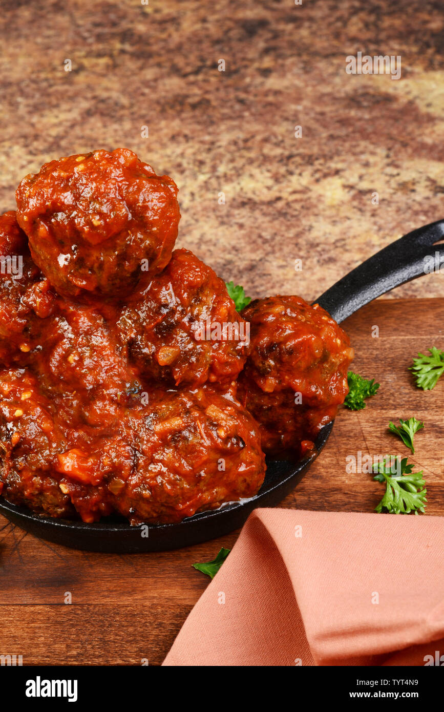 closeup cast iron skillet with tomato meatballs Stock Photo - Alamy