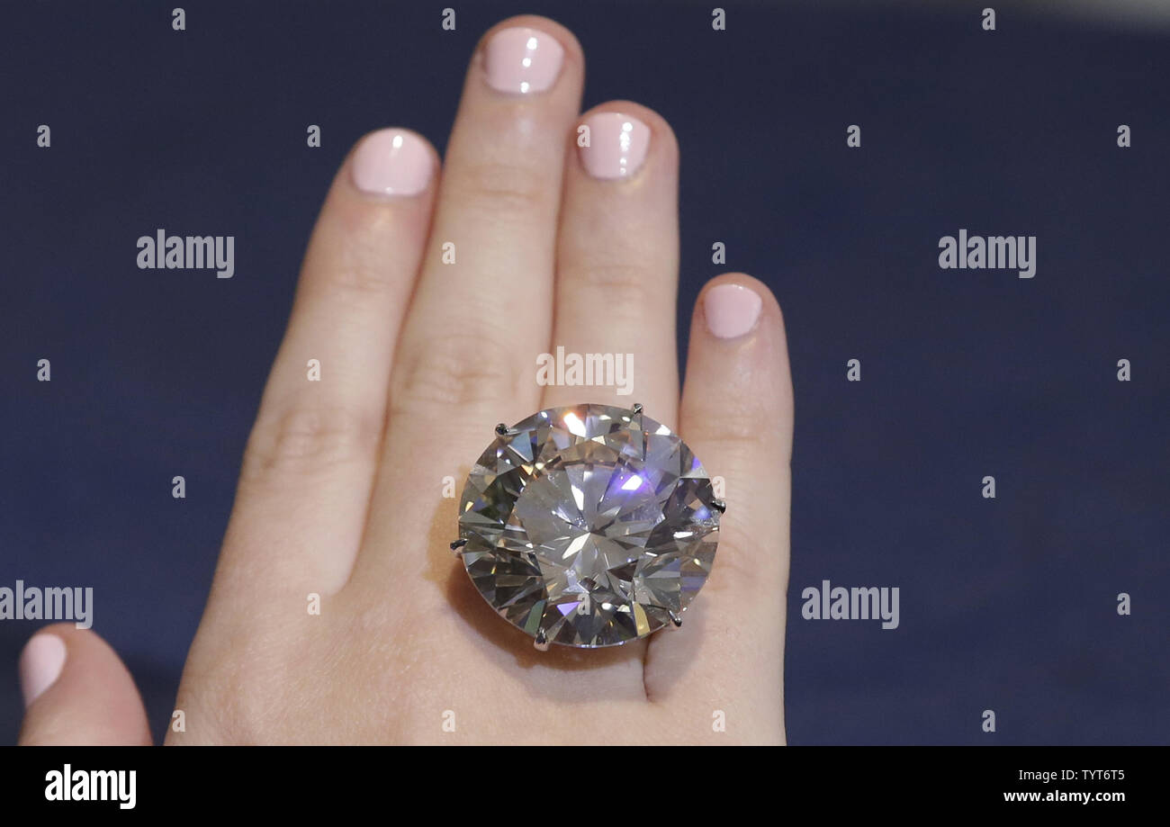 A Sotheby's employee models the largest round diamond ever to appear at ...