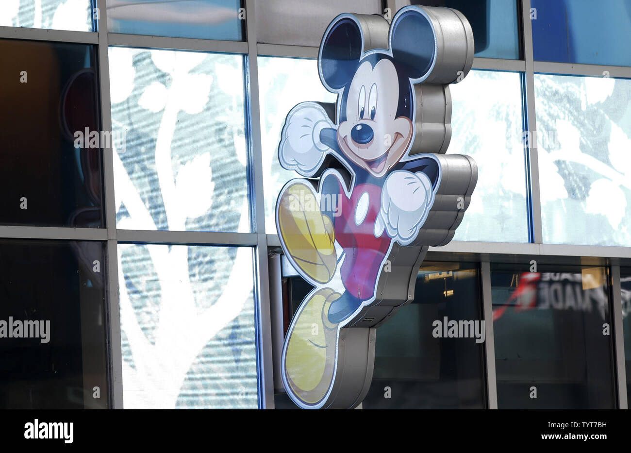 A Mickey Mouse figure hangs above the Disney Store in Time Square on ...