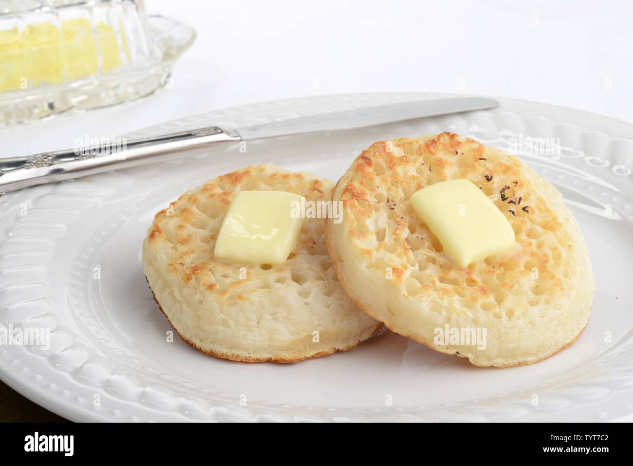english crumpets with a knife Stock Photo - Alamy
