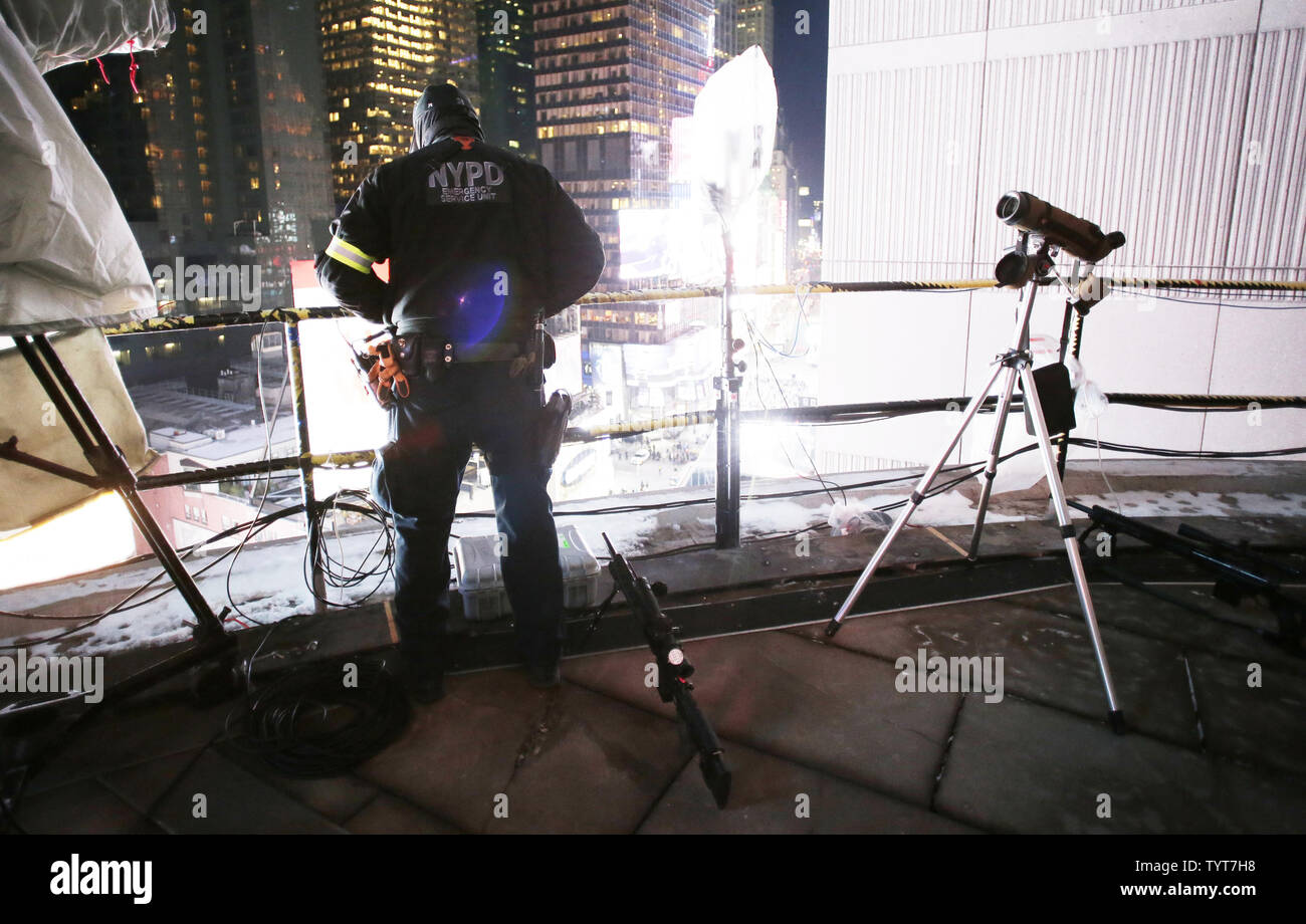 An NYPD Emergency Service Unit Police officer stands next with a sniper ...