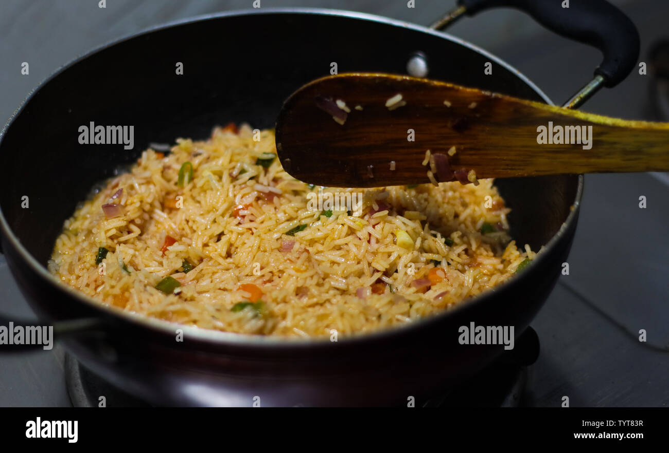 fried rice pulao cooking in a frying pan Stock Photo - Alamy