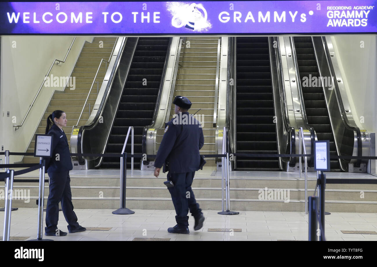 A security guard and an usher stand near escalators 2 days before the ...
