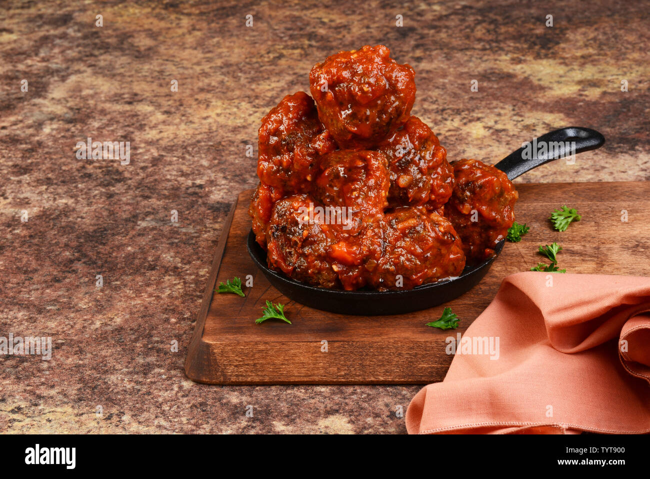 meatballs covered in tomato sauce in cast iron skillet Stock Photo - Alamy