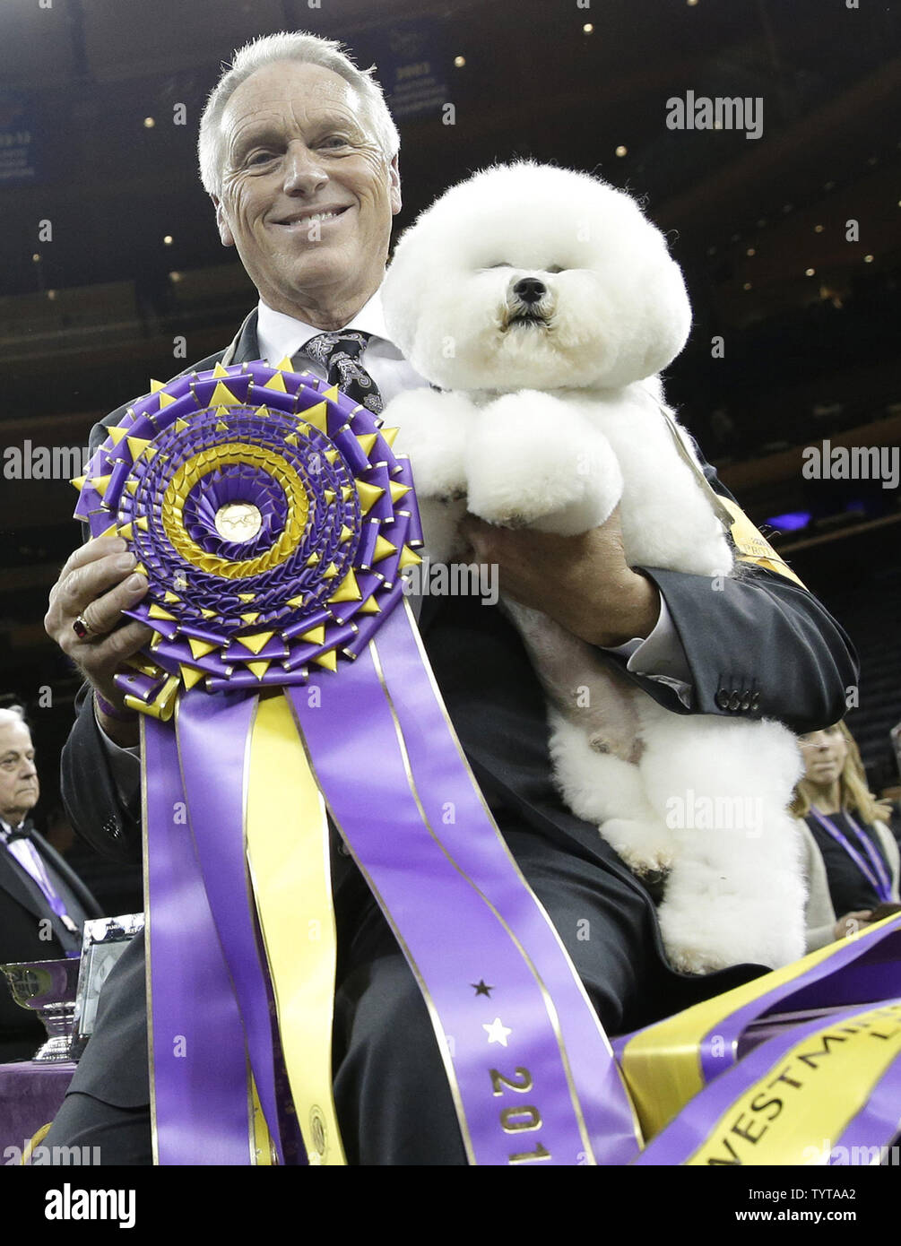 Handler Bill McFadden holds Flynn the Flynn The Bichon Frise after the ...