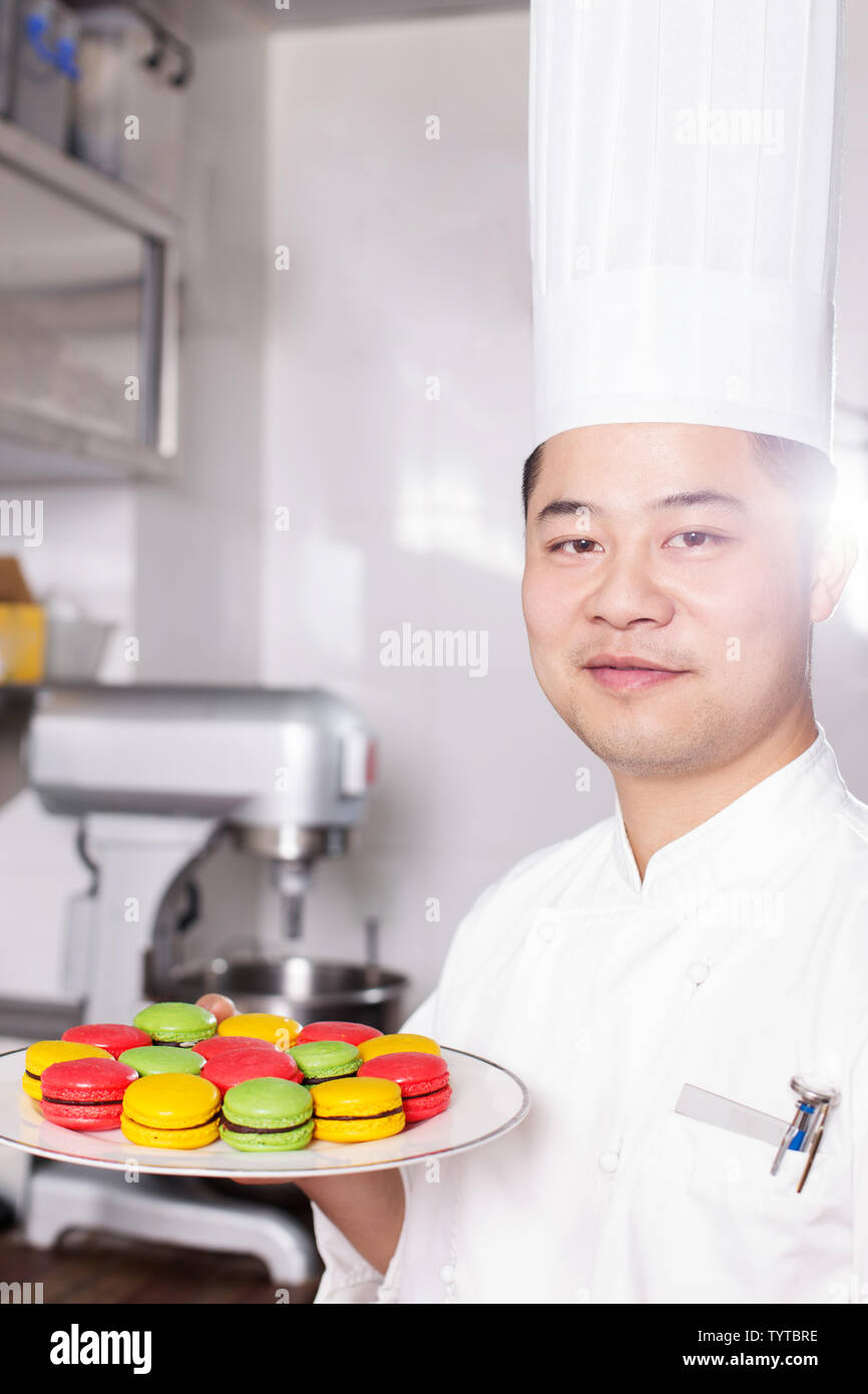 young chinese man chelf making food in modern kitchen Stock Photo - Alamy