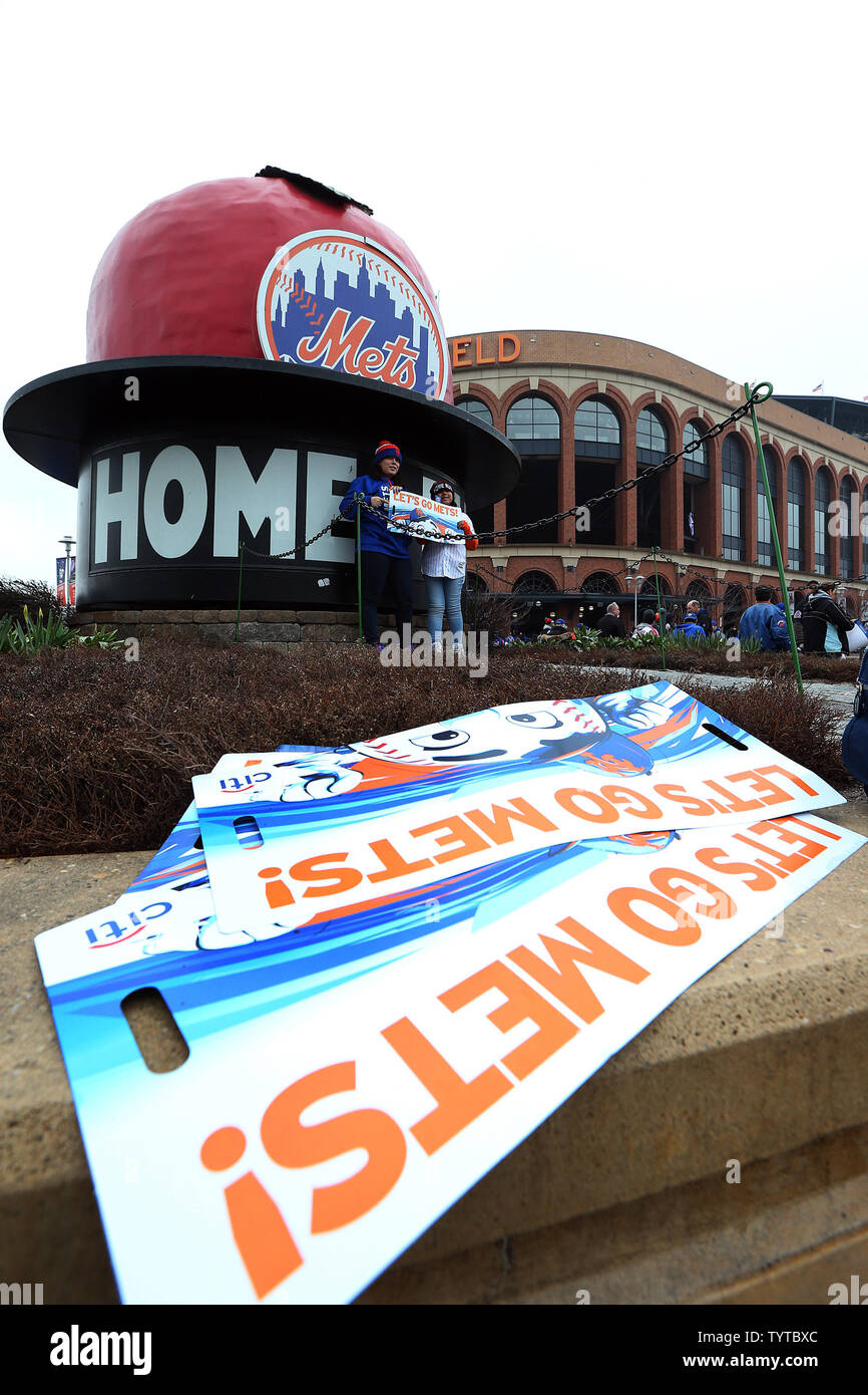 Fans pose for a photo in front of the Home Run Apple before an Opening ...