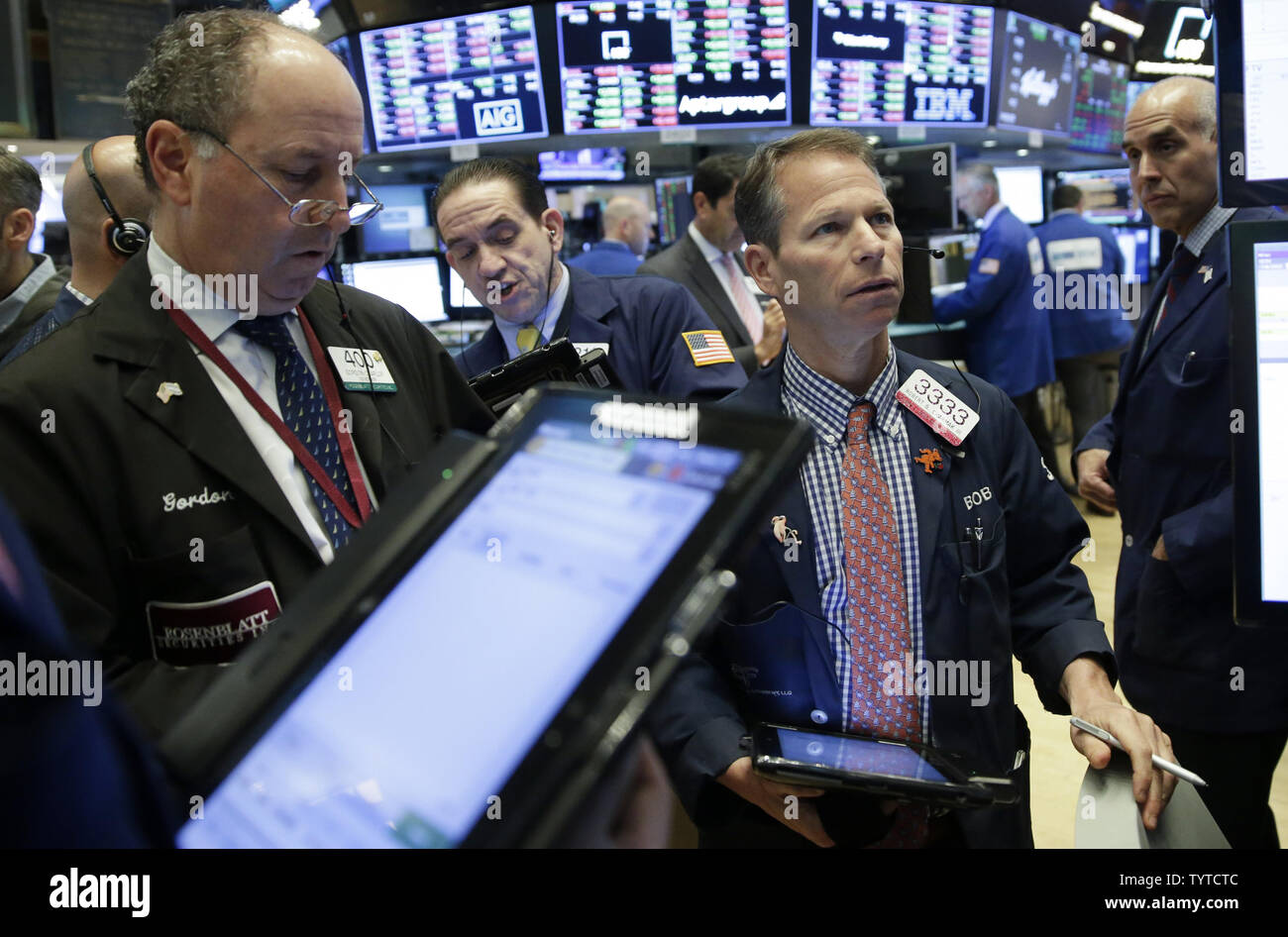 Traders work on the floor of the NYSE at the opening bell at the New ...