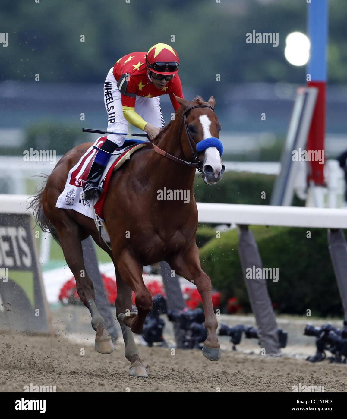Jockey Mike Smith aboard Justify (R) races towards the finish line to ...