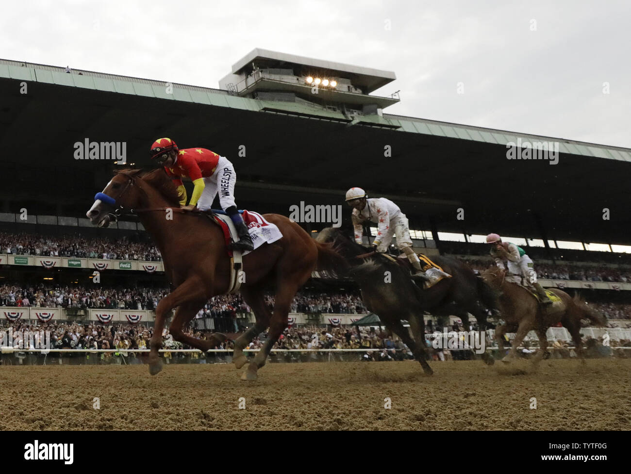 Jockey Mike Smith aboard Justify (L) races past the finish line to win ...