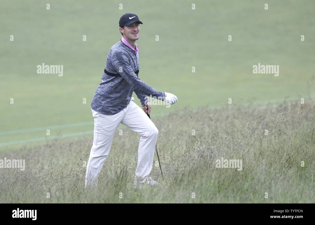 Cameron Wilson smiles walking through the rough in a practice round on ...