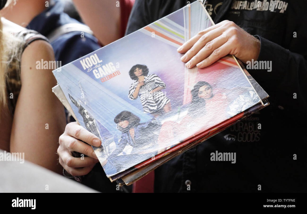 A fan holds a record album of Kool and the Gang to be signed at the ...