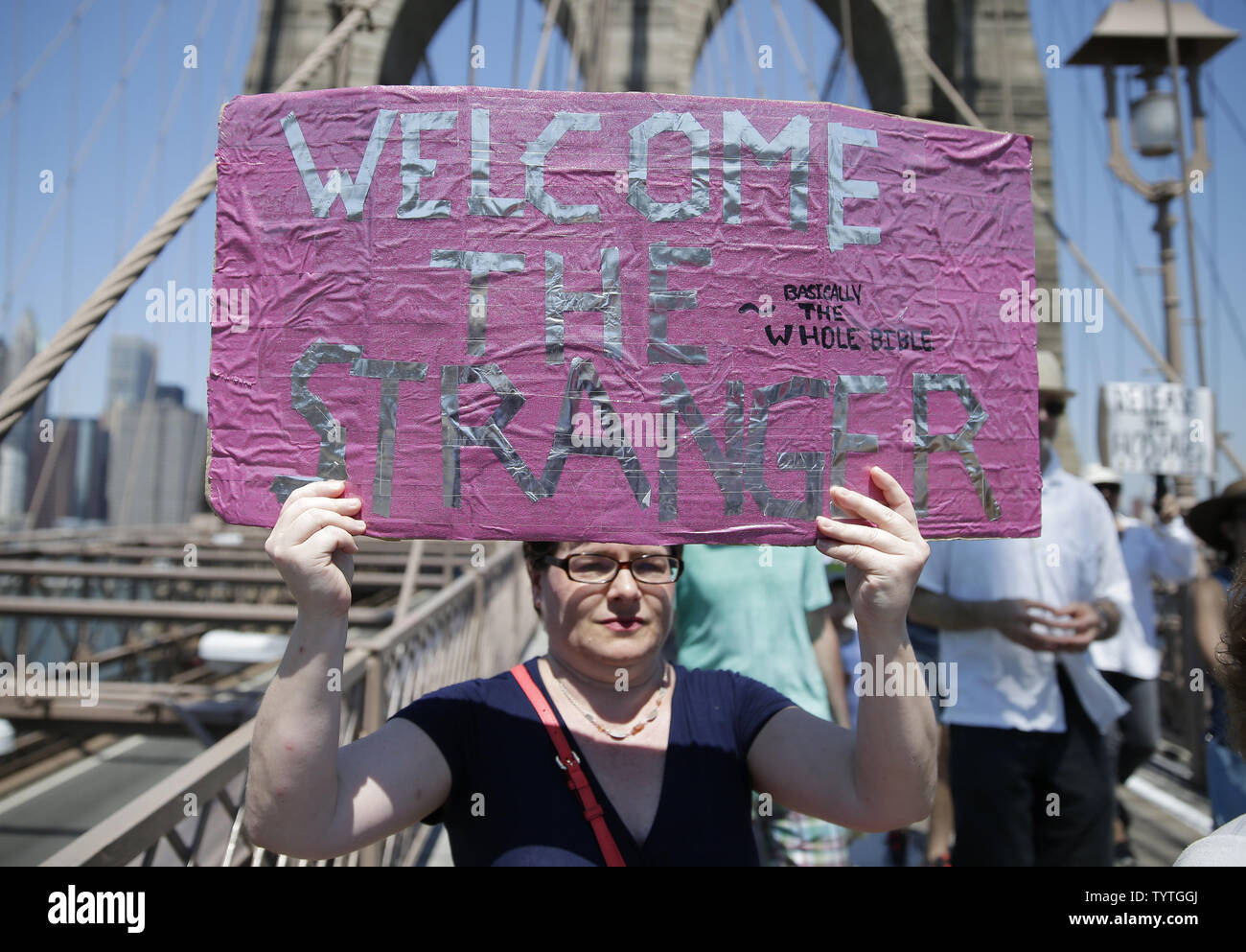 Protesters hold up signs at the End Family Separation NYC Rally and ...