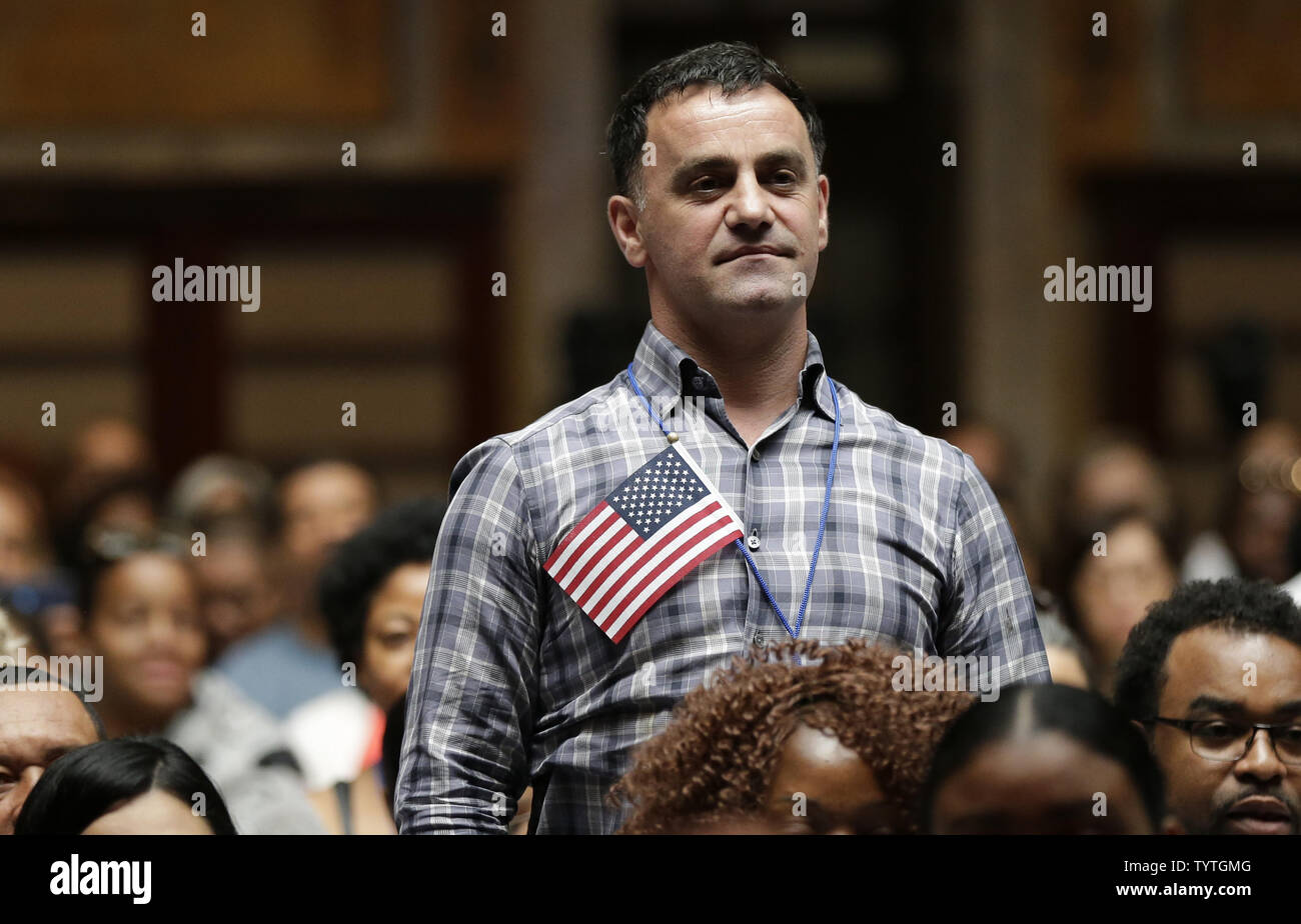 New citizens of the United States of America hold American Flags when U ...