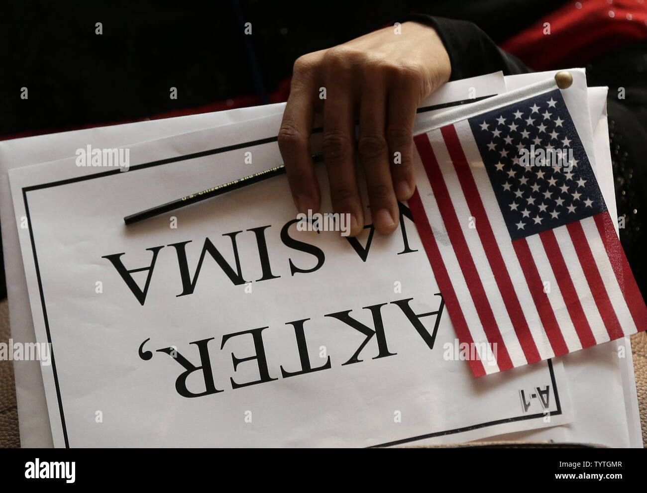 New citizens of the United States of America hold American Flags when U ...