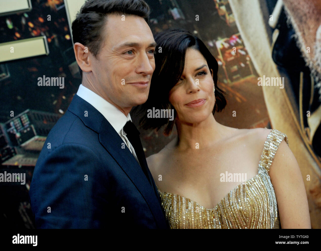 Neve Campbell and JJ Feild arrive on the red carpet at the 'Skyscraper ...