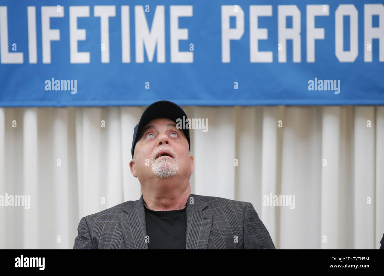 Billy Joel speaks looks up at his name on a large monitor at a press ...