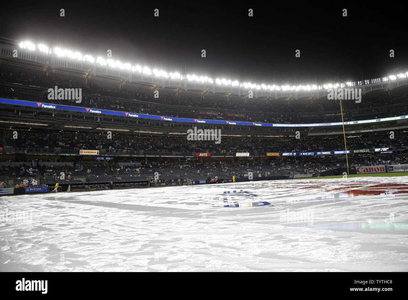 A rain tarp covers the infield in a rain delay before the New York ...