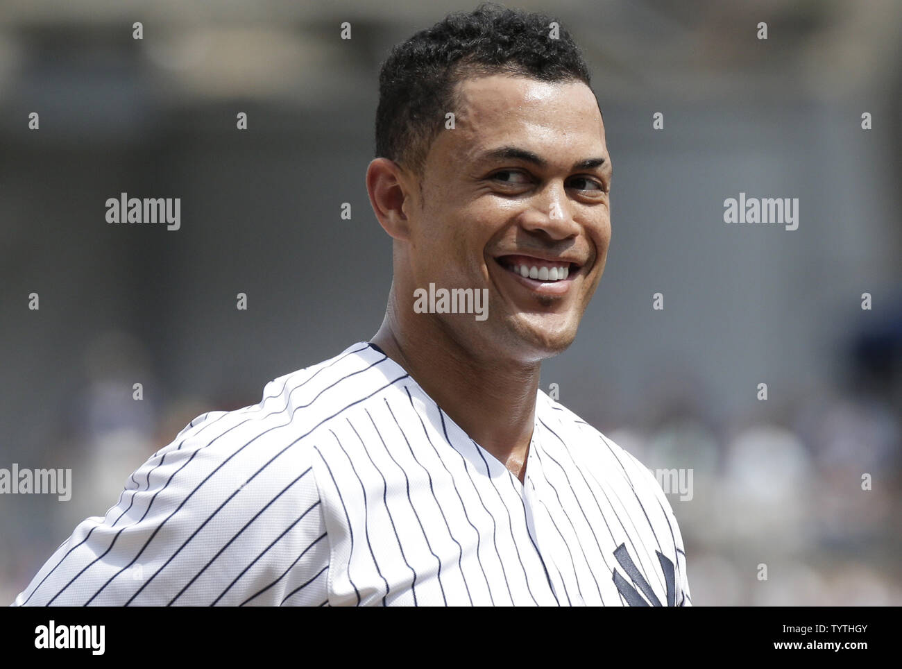 New York Yankees Giancarlo Stanton smiles while he stands on third base ...