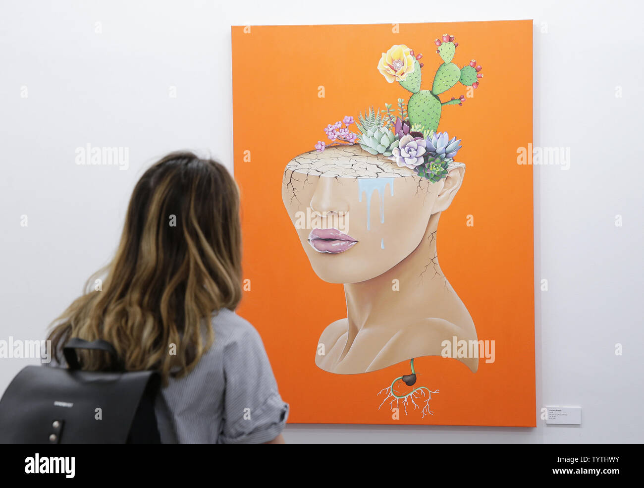 A painting titled "Still Bloomed" is on display at the "You Deserve A ...