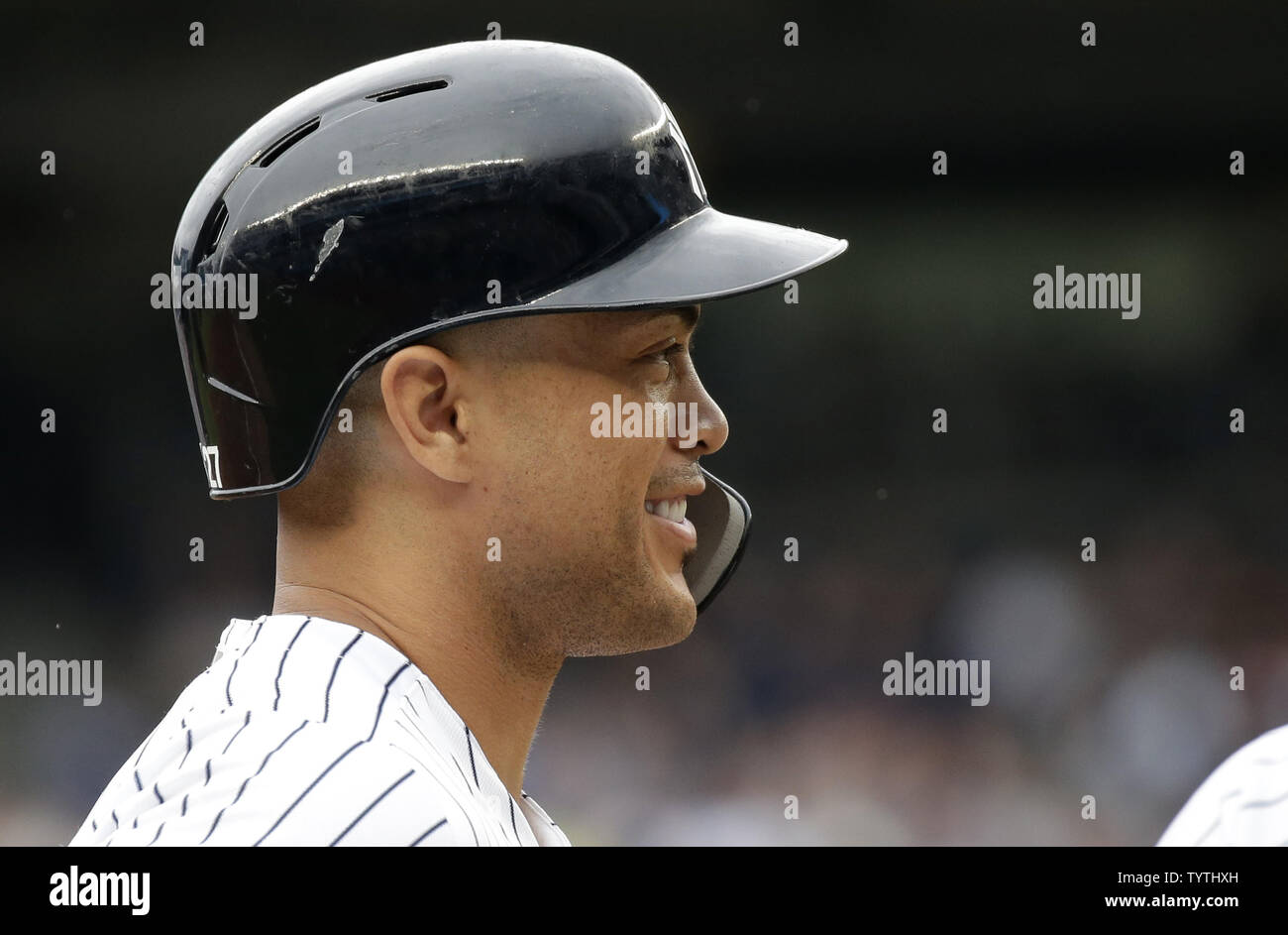 New York Yankees Giancarlo Stanton smiles standing on third base in the ...