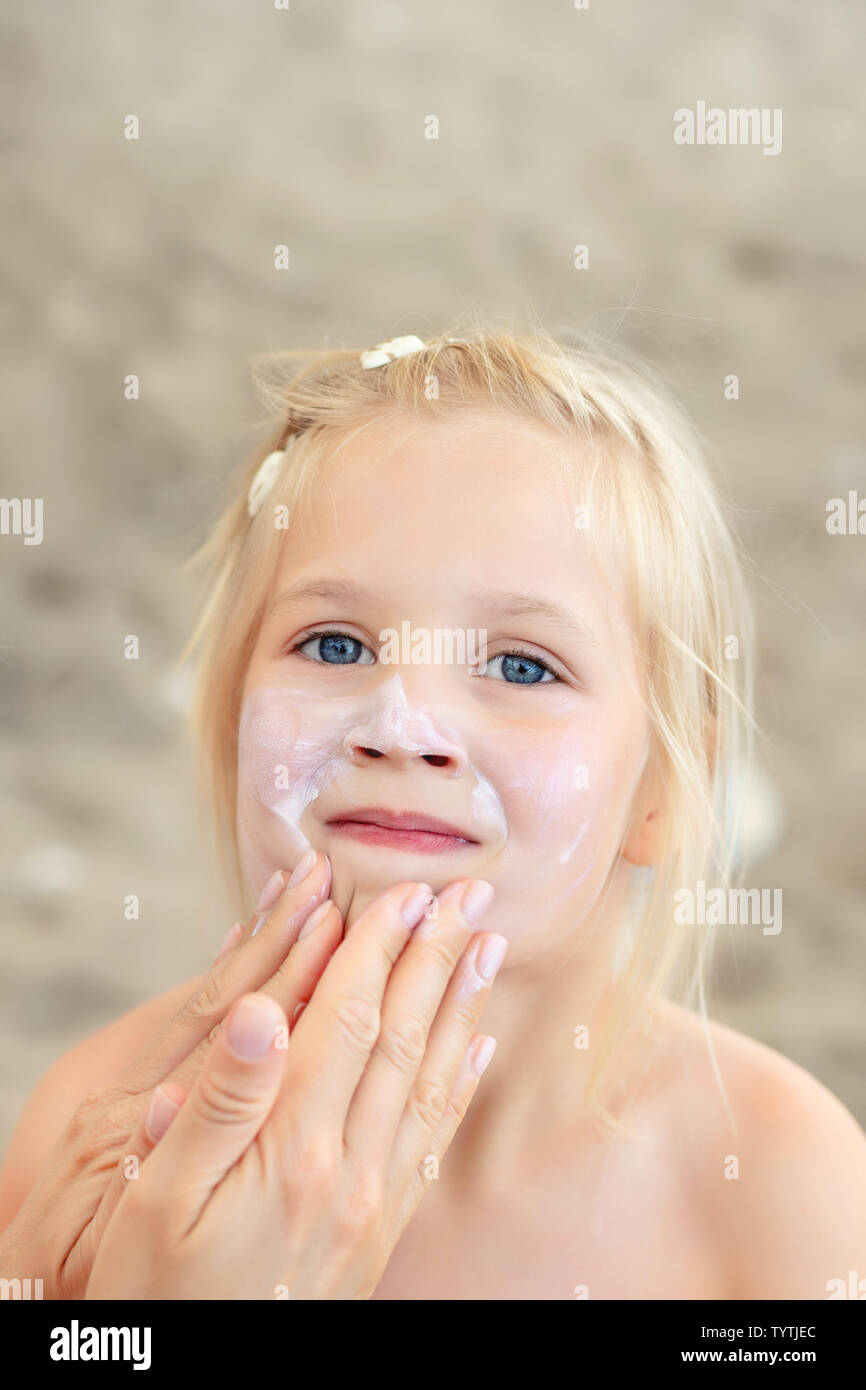 Applying sunscreen daughter on beach hi-res stock photography and ...