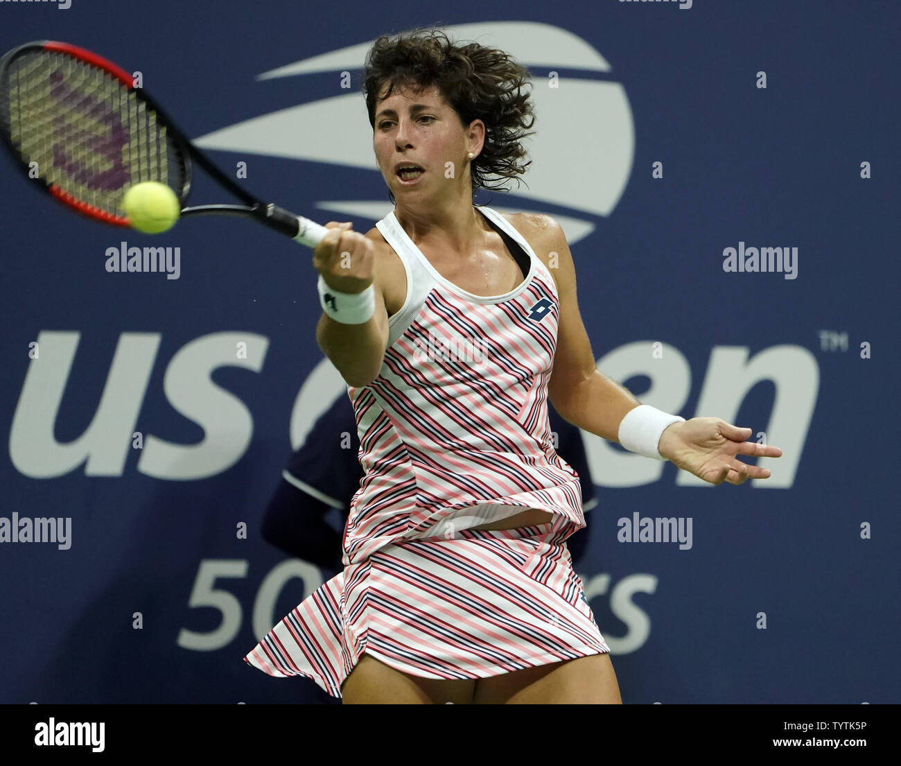 Carla Suarez Navarro of Spain returns a shot from Maria Sharapova of ...