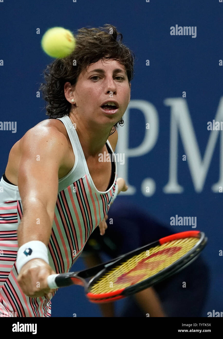 Carla Suarez Navarro of Spain returns a shot from Maria Sharapova of ...