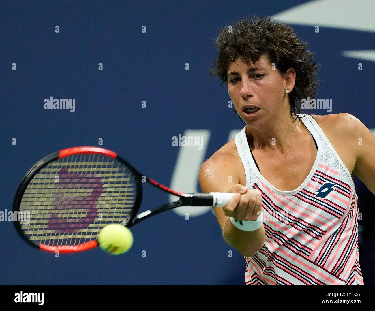 Carla Suarez Navarro of Spain returns a shot from Maria Sharapova of ...