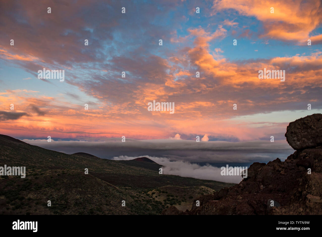 In the distance is a volcano erupting on the Big Island of Hawaii Stock ...
