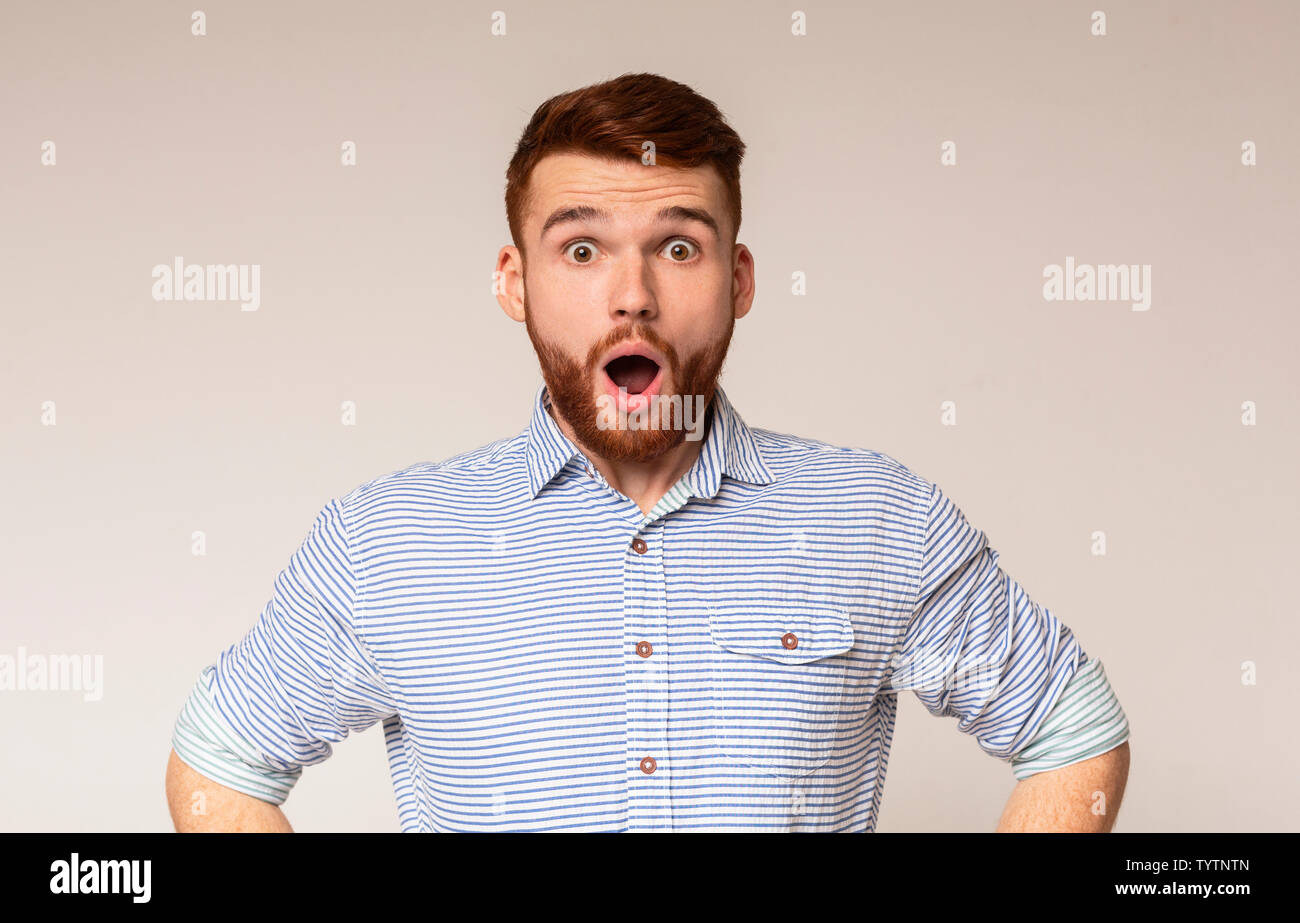 Surprised man with shocked look on studio background Stock Photo - Alamy